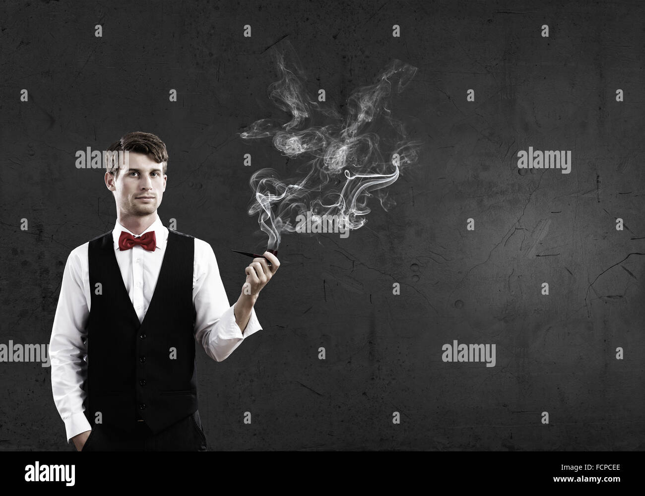 Handsome young businessman thinking over ideas and smoking pipe Stock ...