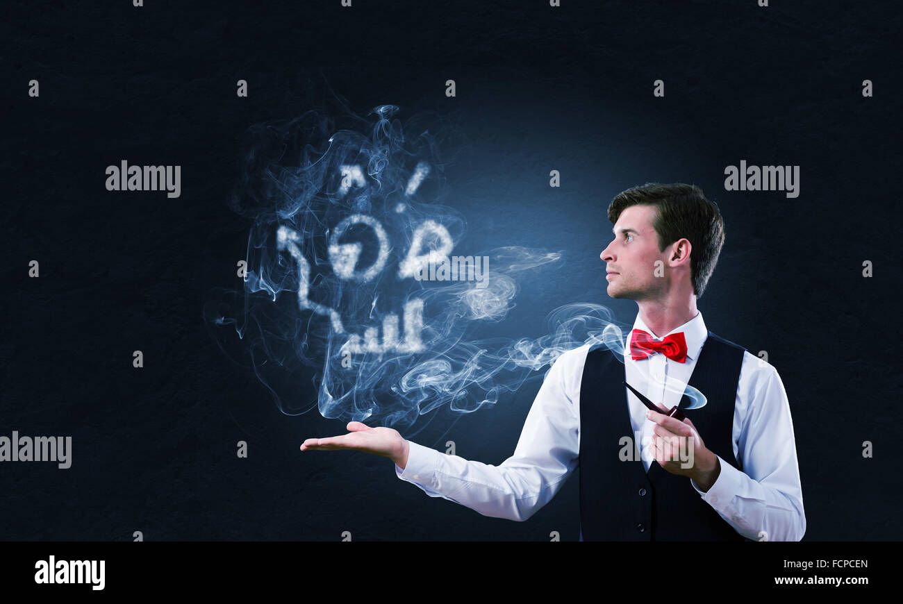 Handsome young businessman thinking over ideas and smoking pipe Stock ...