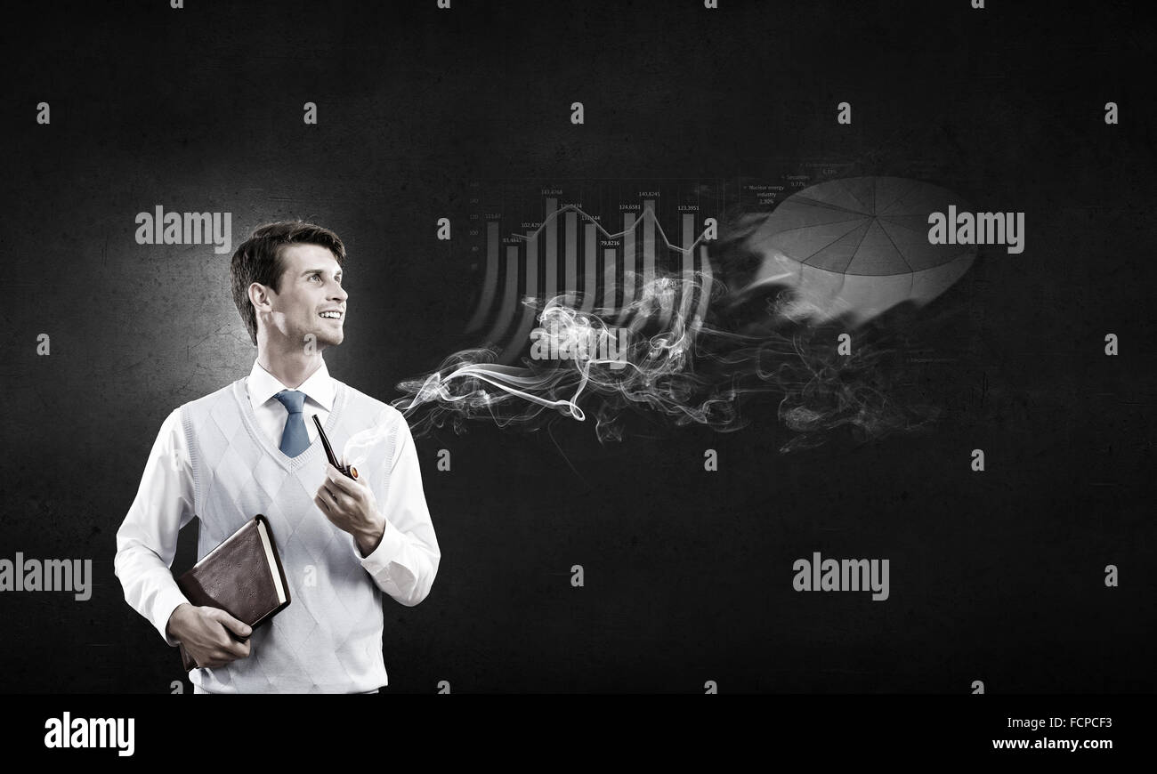 Handsome young businessman thinking over ideas and smoking pipe Stock ...