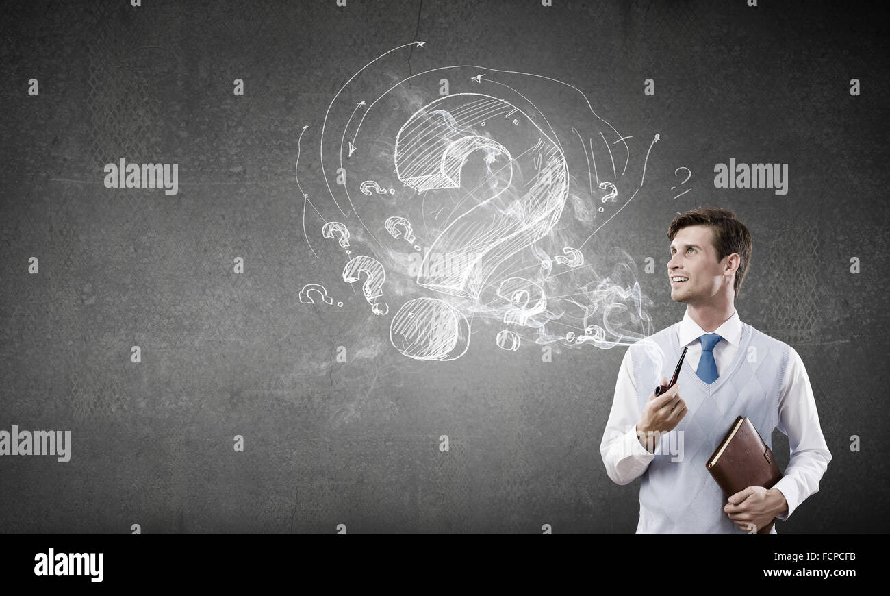 Handsome young businessman thinking over ideas and smoking pipe Stock ...