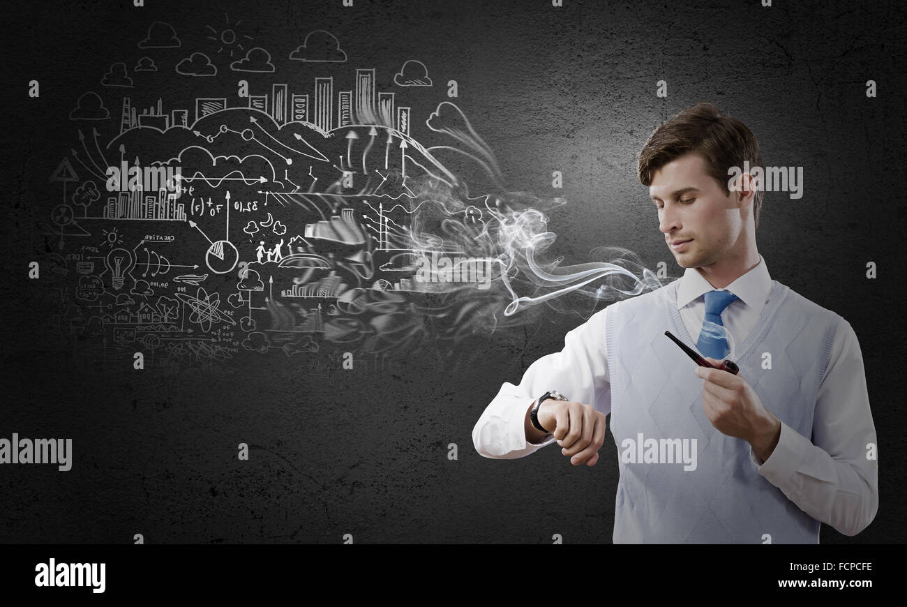 Handsome young businessman thinking over ideas and smoking pipe Stock ...