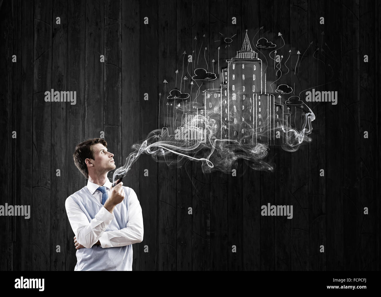 Handsome young businessman thinking over ideas and smoking pipe Stock ...