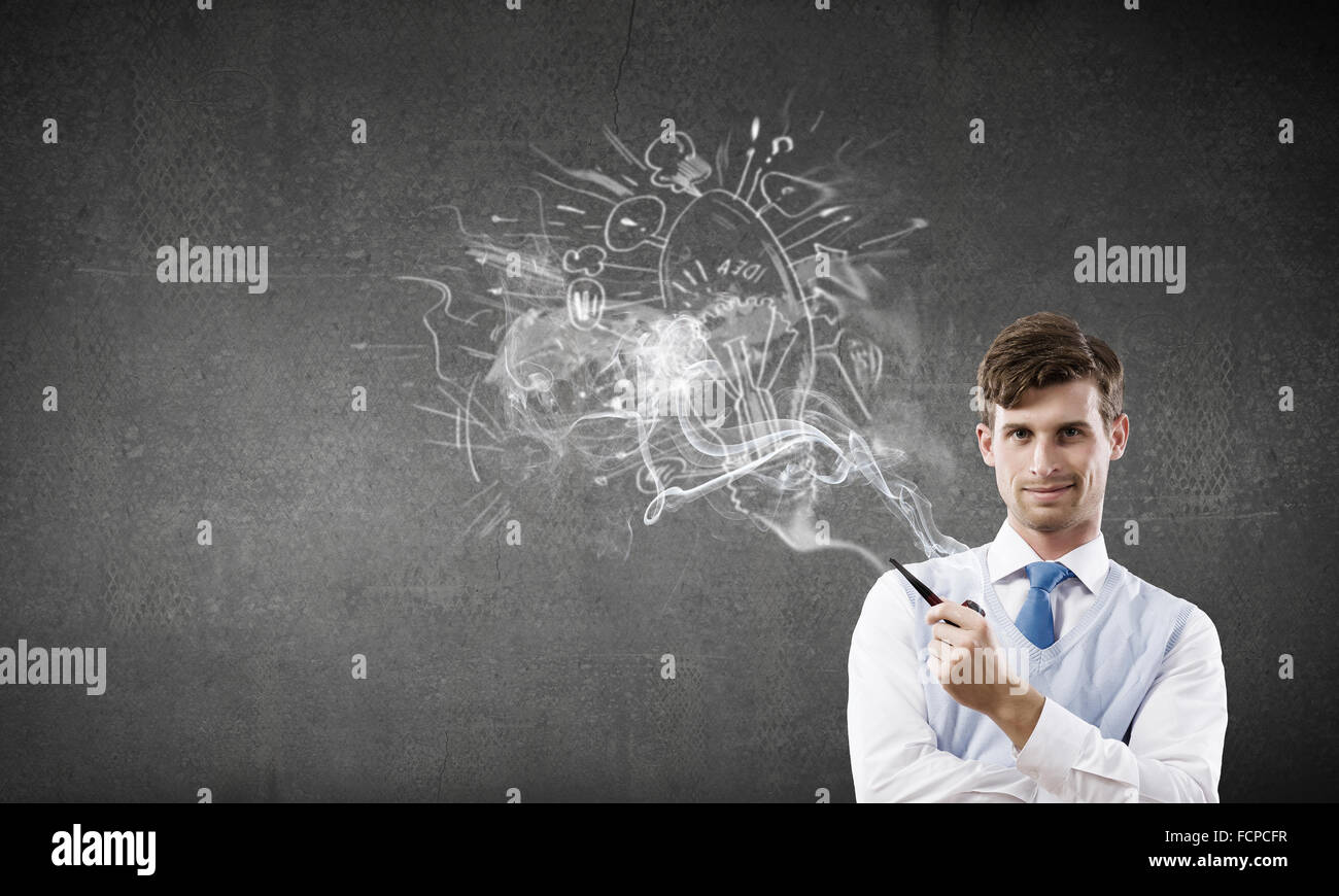 Handsome young businessman thinking over ideas and smoking pipe Stock ...