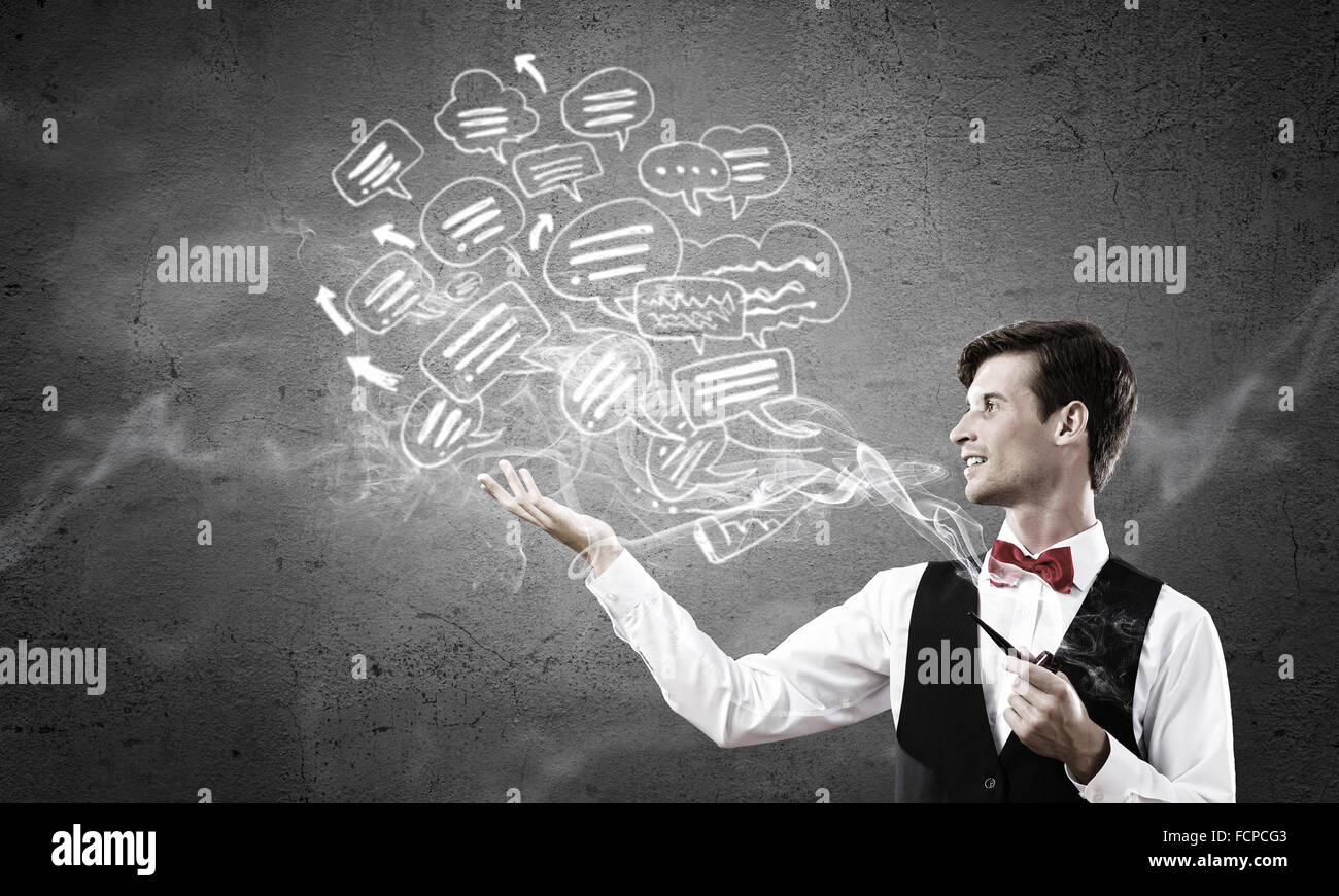 Handsome young businessman thinking over ideas and smoking pipe Stock ...