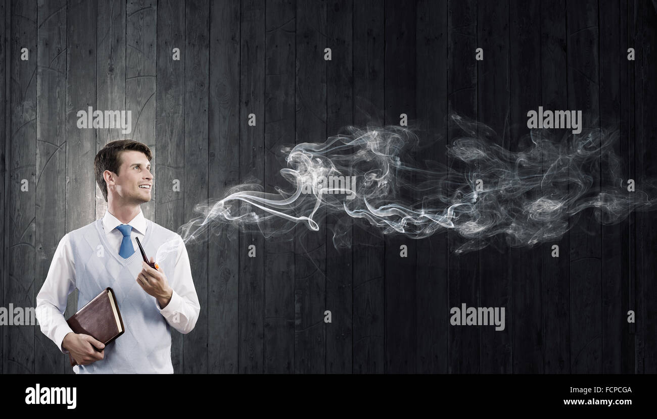 Handsome young businessman thinking over ideas and smoking pipe Stock ...