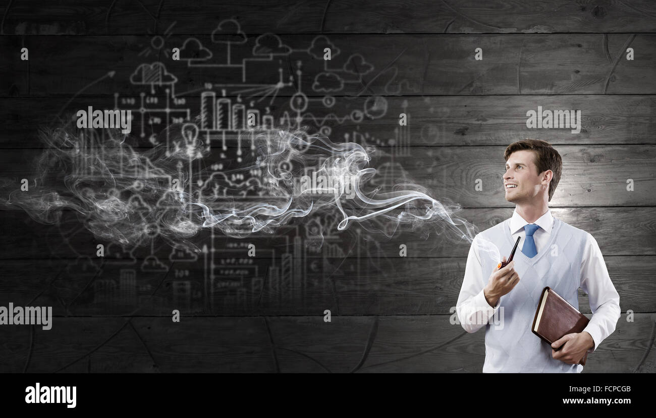 Handsome young businessman thinking over ideas and smoking pipe Stock ...