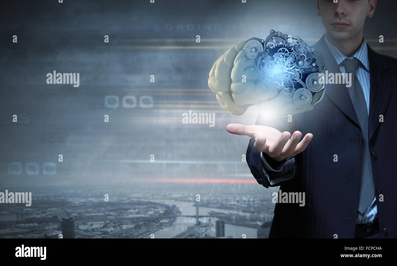 Close up of businessman holding human brain with working gears Stock ...