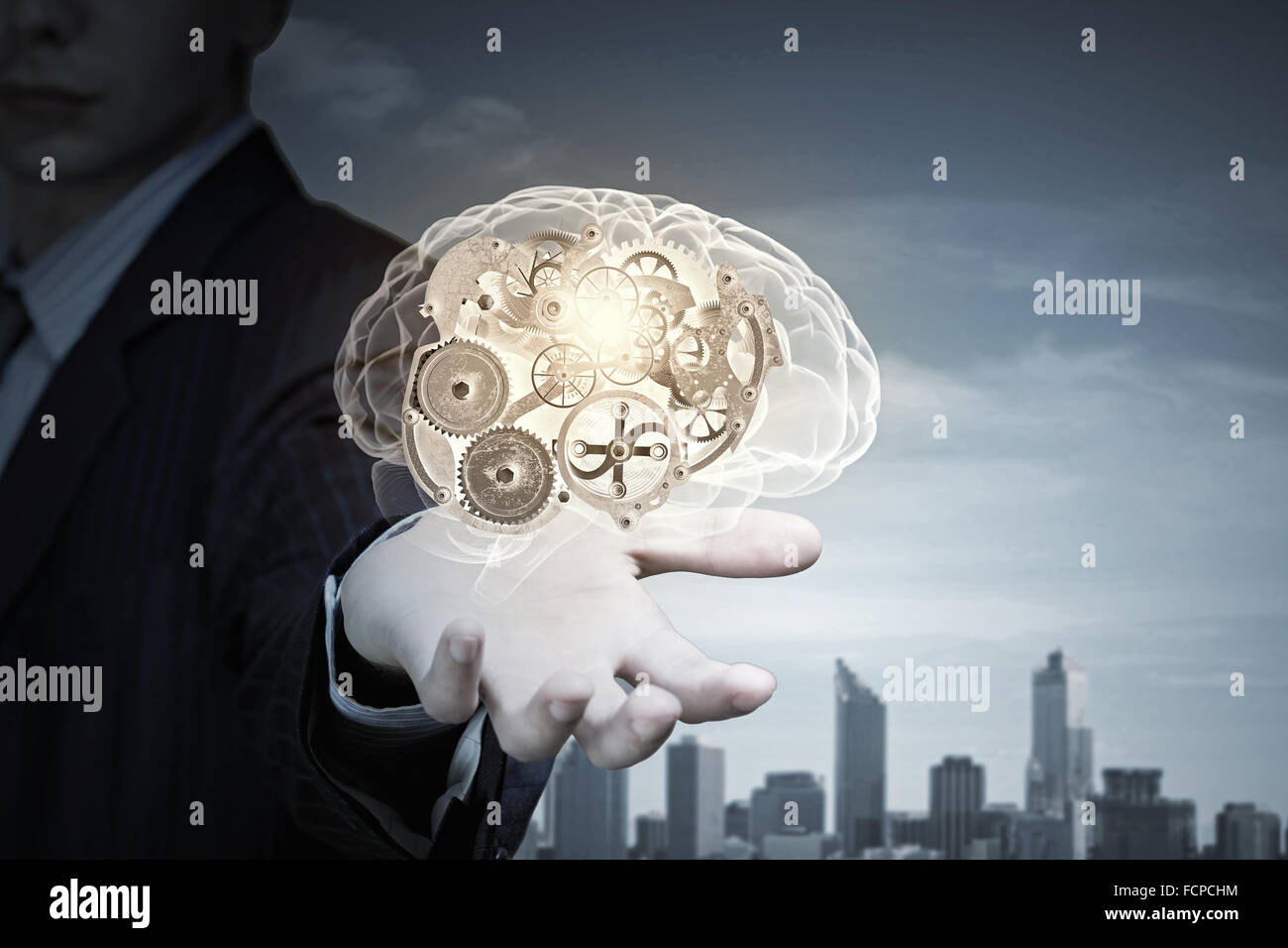 Close up of businessman holding human brain with working gears Stock ...