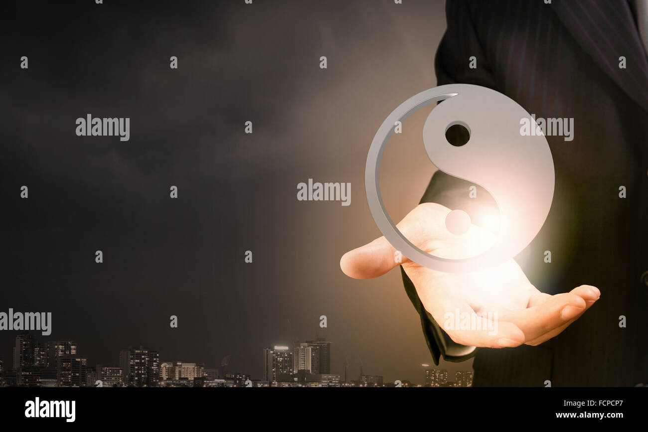 Close up of businessman holding ying yan symbol in palm Stock Photo - Alamy