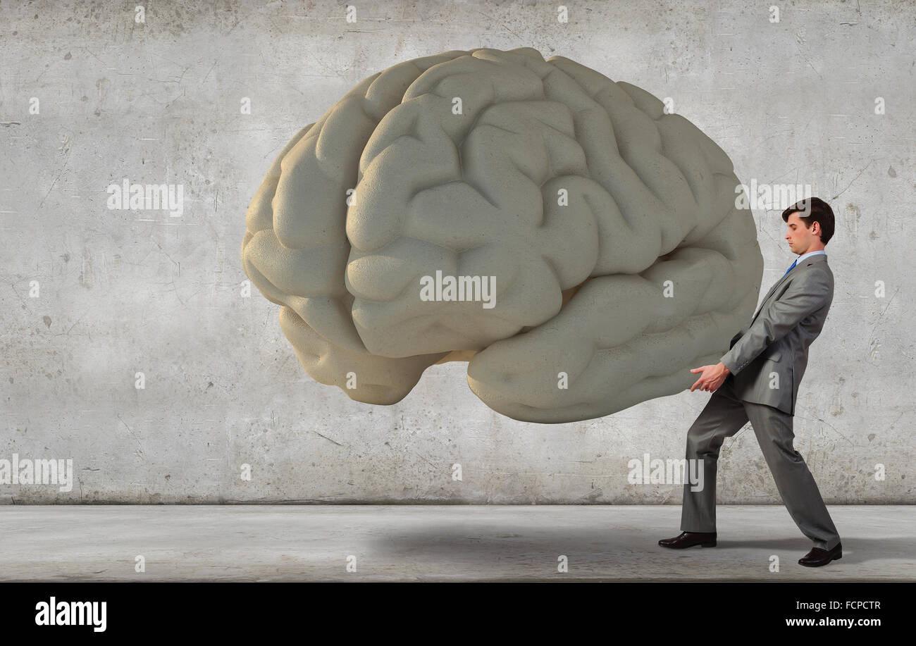 Businessman making effort to carry huge human brain Stock Photo - Alamy