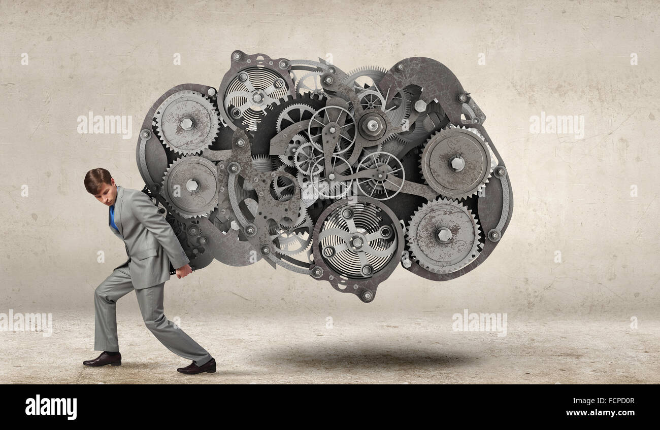 Young businessman carrying huge gears mechanism on back Stock Photo - Alamy