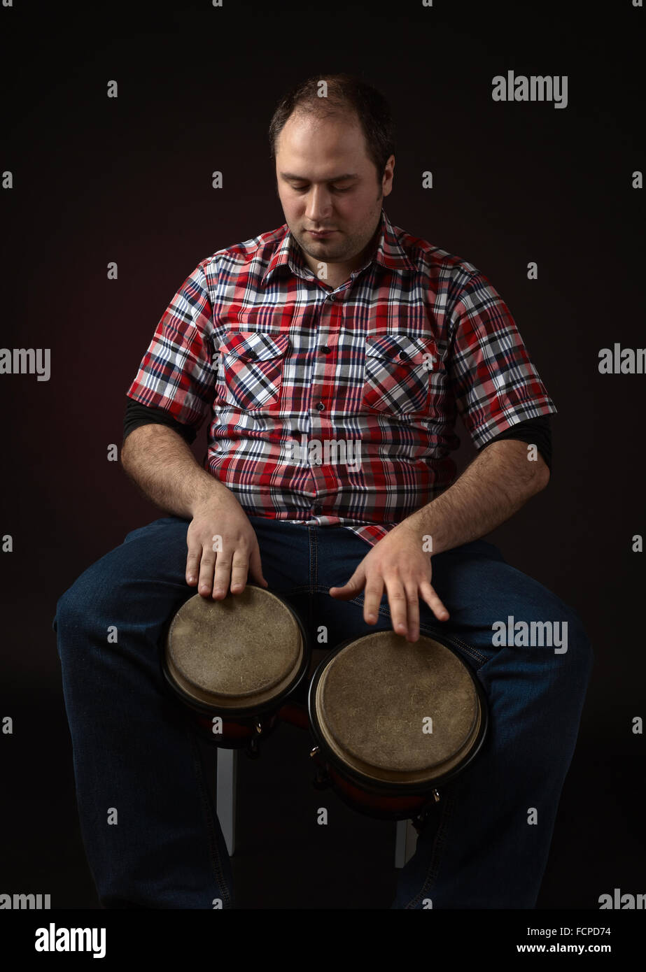 portrait of musician with bongo , studio shot Stock Photo - Alamy