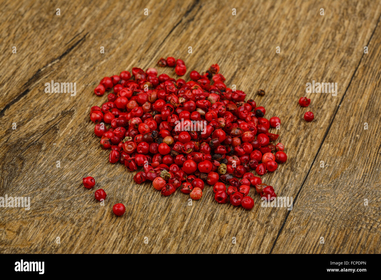 Dry Rose pepper corn on the wood background Stock Photo - Alamy