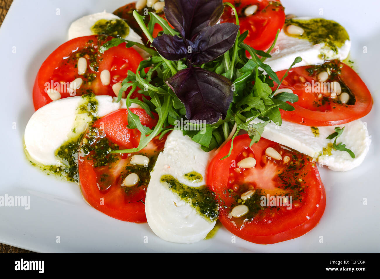 Italian traditional Caprese salad with cedar nuts Stock Photo - Alamy