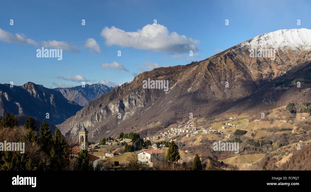 landscape with mountain village and the rocky slope of Menna peak in ...