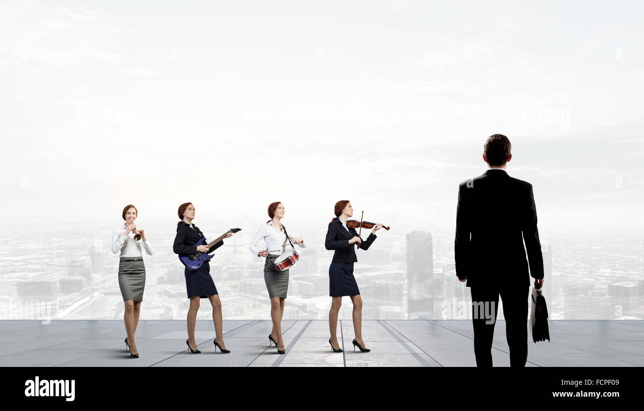 Young woman in suit playing different music instruments Stock Photo - Alamy