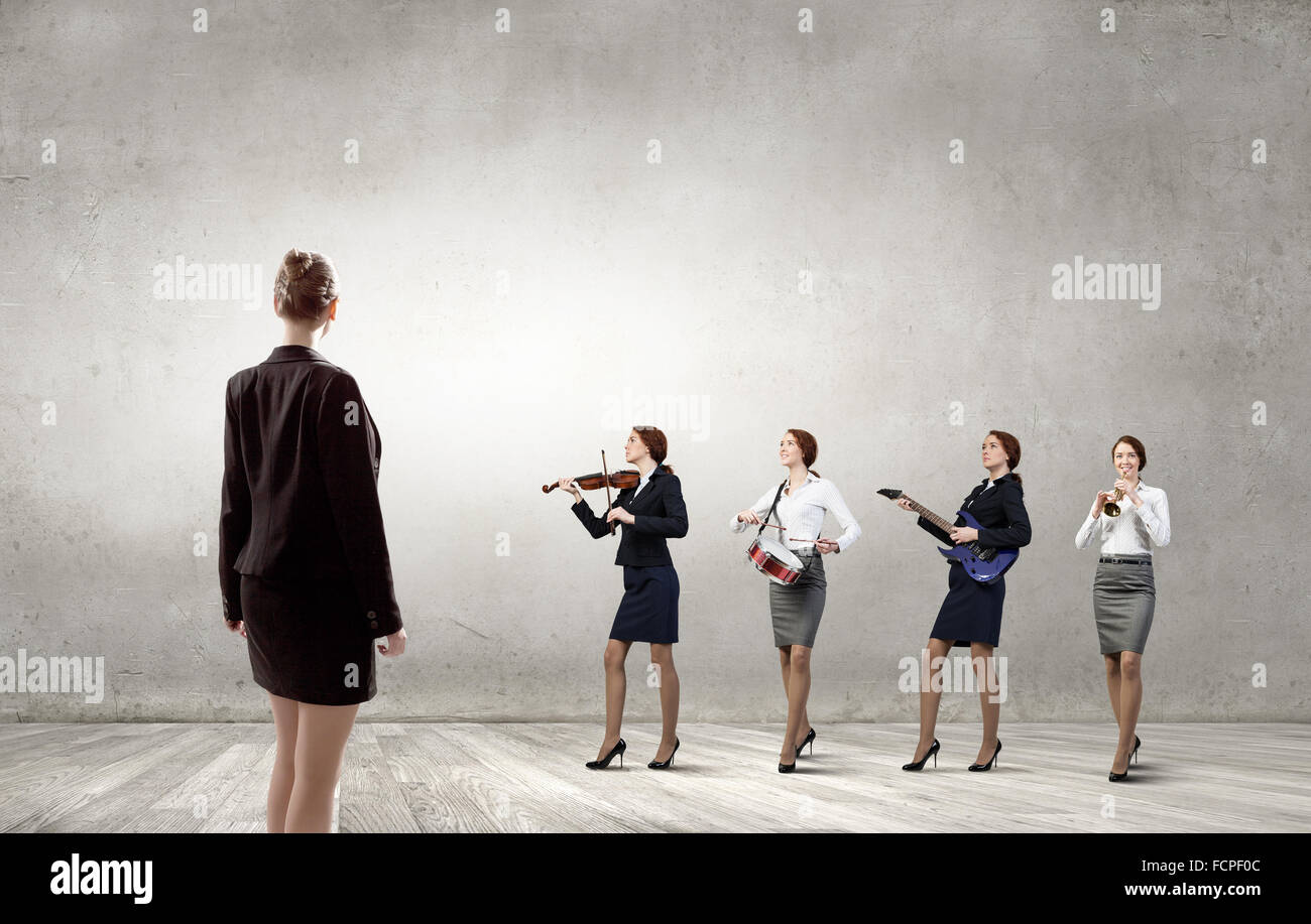 Young woman in suit playing different music instruments Stock Photo - Alamy