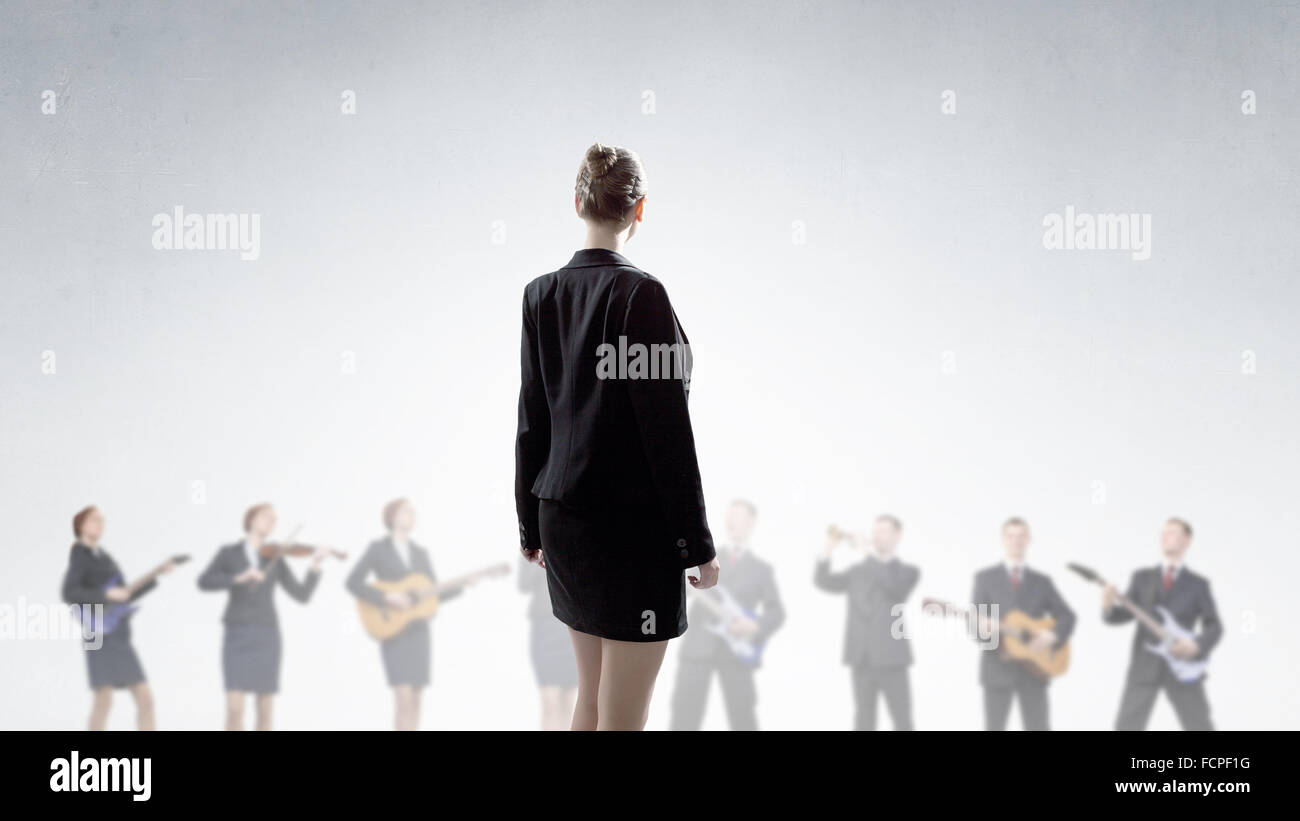 Young woman in suit playing different music instruments Stock Photo - Alamy