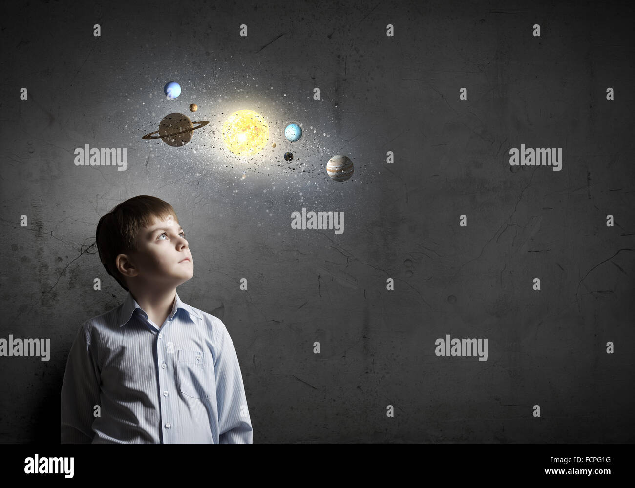 Cute boy of school age exploring space system Stock Photo - Alamy