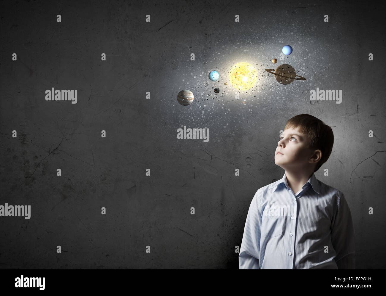 Cute boy of school age exploring space system Stock Photo - Alamy