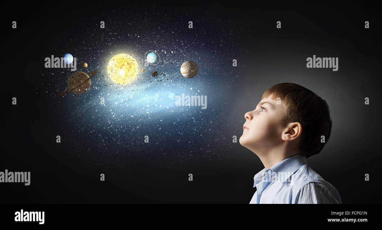 Cute boy of school age exploring space system Stock Photo - Alamy