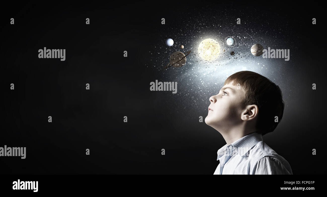 Cute boy of school age exploring space system Stock Photo - Alamy