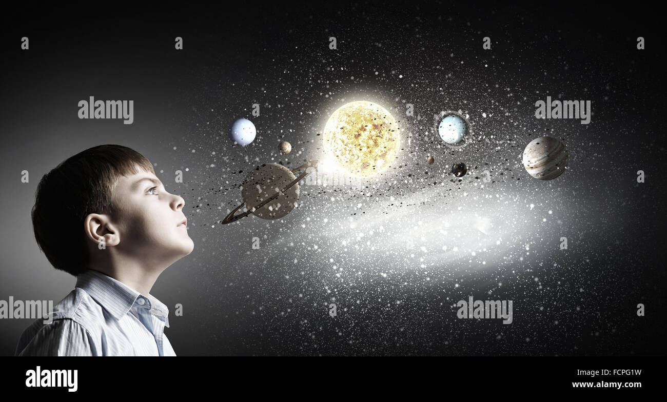 Cute boy of school age exploring space system Stock Photo - Alamy