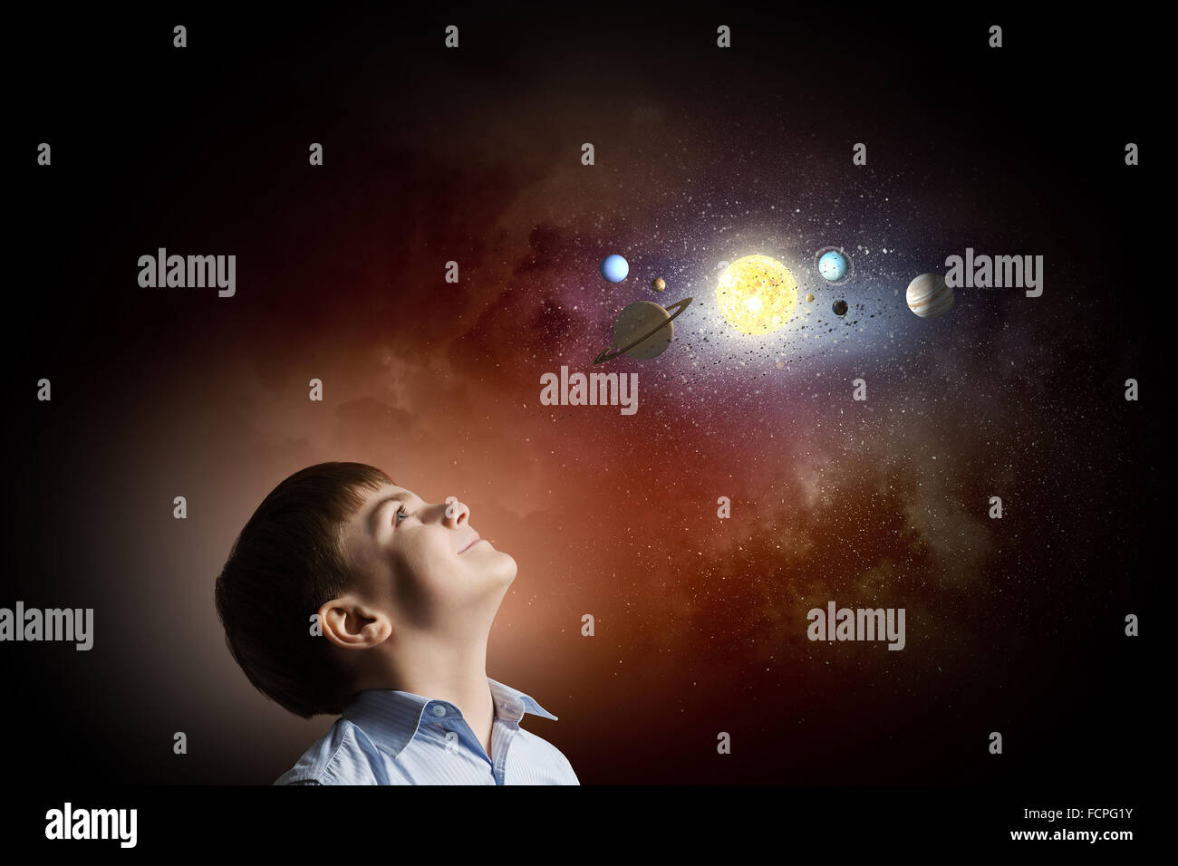 Cute boy of school age exploring space system Stock Photo - Alamy