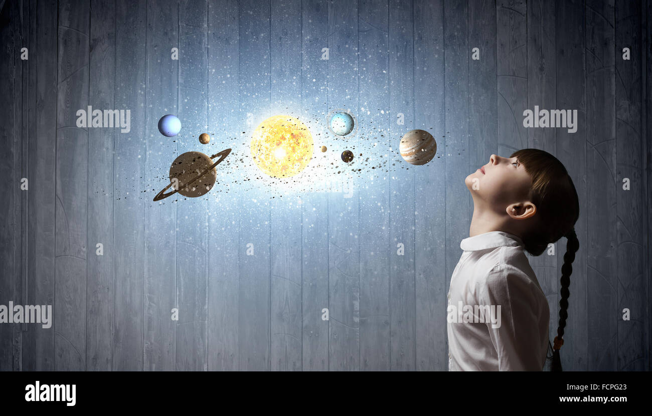 Cute girl of school age exploring space system Stock Photo - Alamy