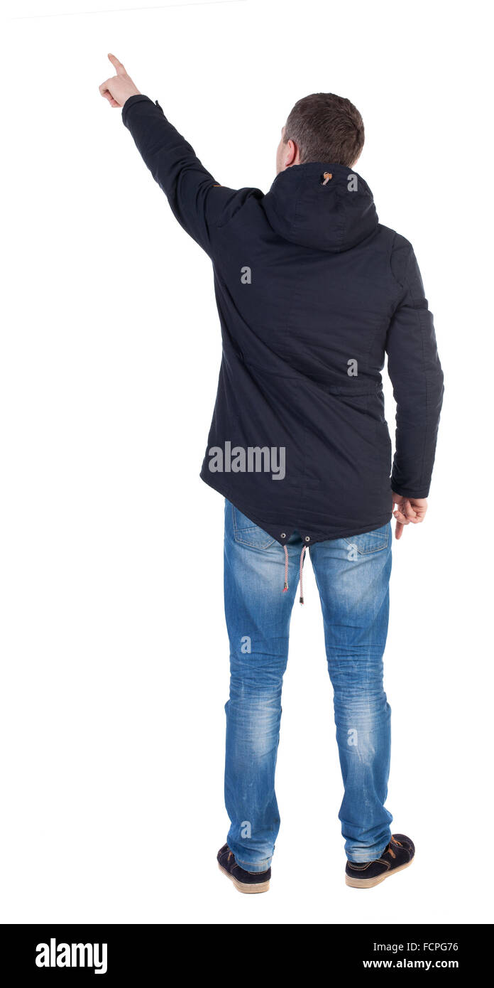 Back view of pointing young men in parka. Young guy gesture. Rear view ...