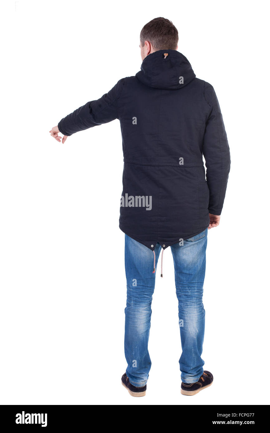Back view of pointing young men in parka. Young guy gesture. Rear view ...
