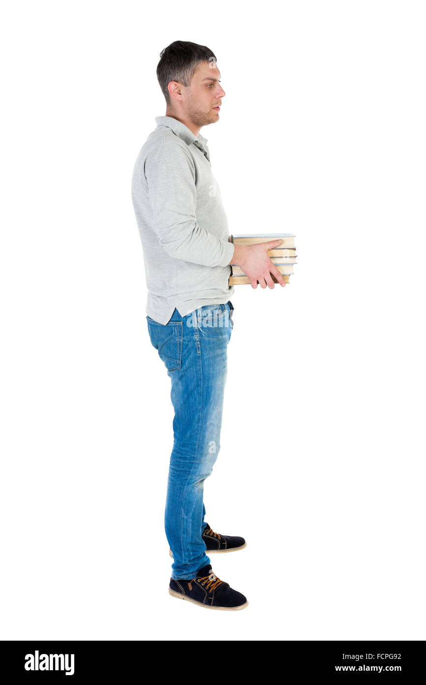 Back view of going handsome man carries a stack of books. walking young ...