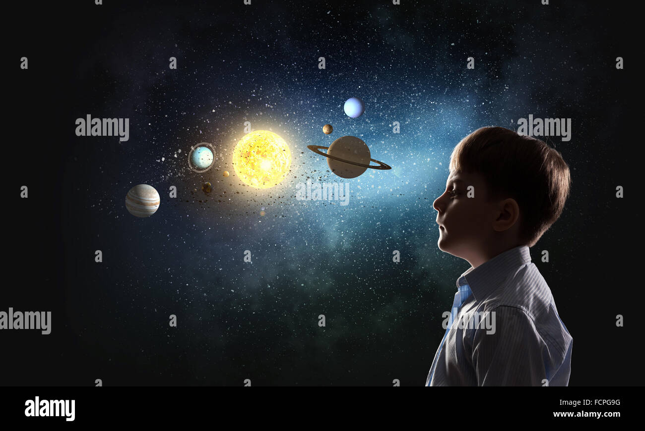 Cute boy of school age exploring space system Stock Photo - Alamy