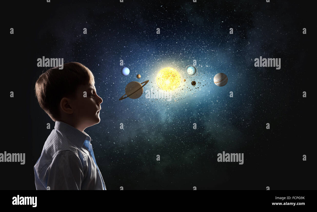 Cute boy of school age exploring space system Stock Photo - Alamy