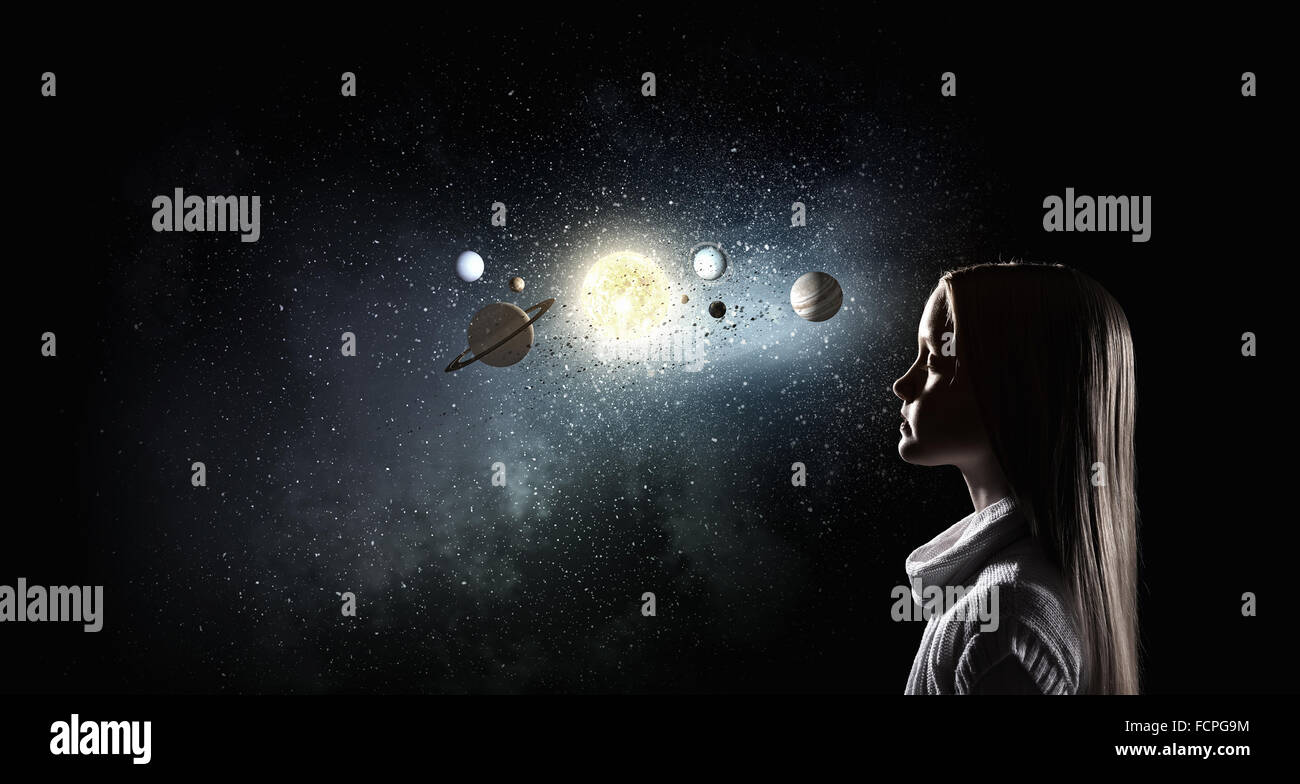Cute girl of school age exploring space system Stock Photo - Alamy