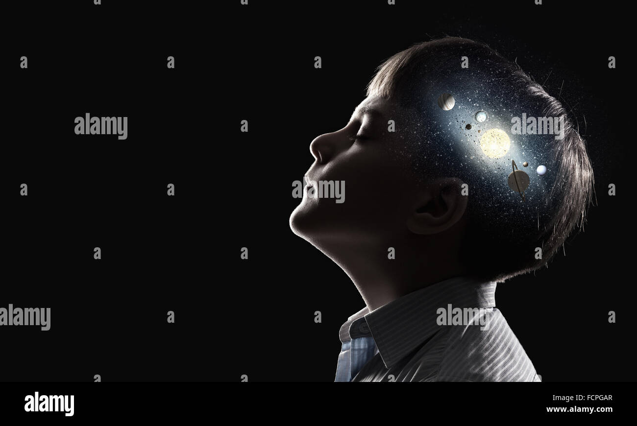 Cute boy of school age exploring space system Stock Photo - Alamy
