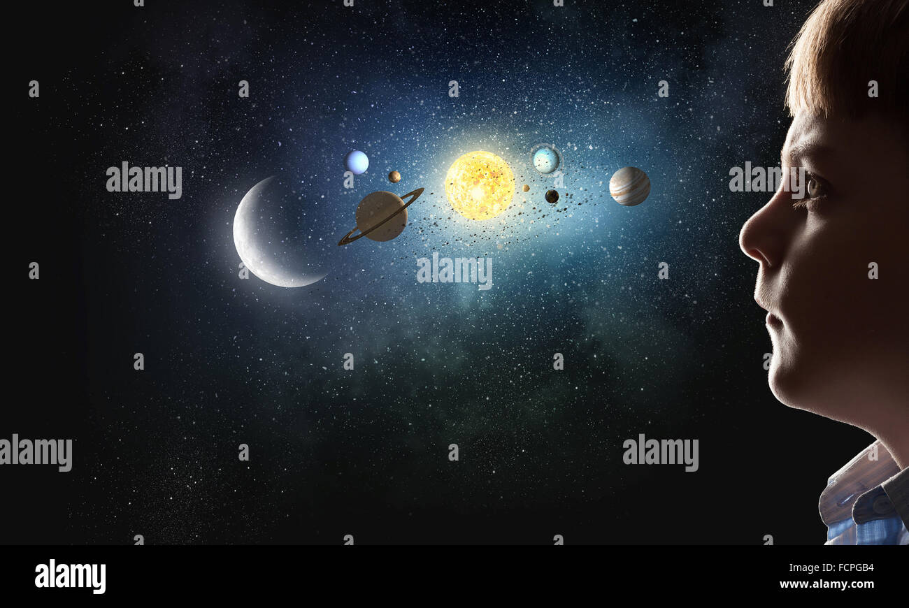 Cute boy of school age exploring space system Stock Photo - Alamy