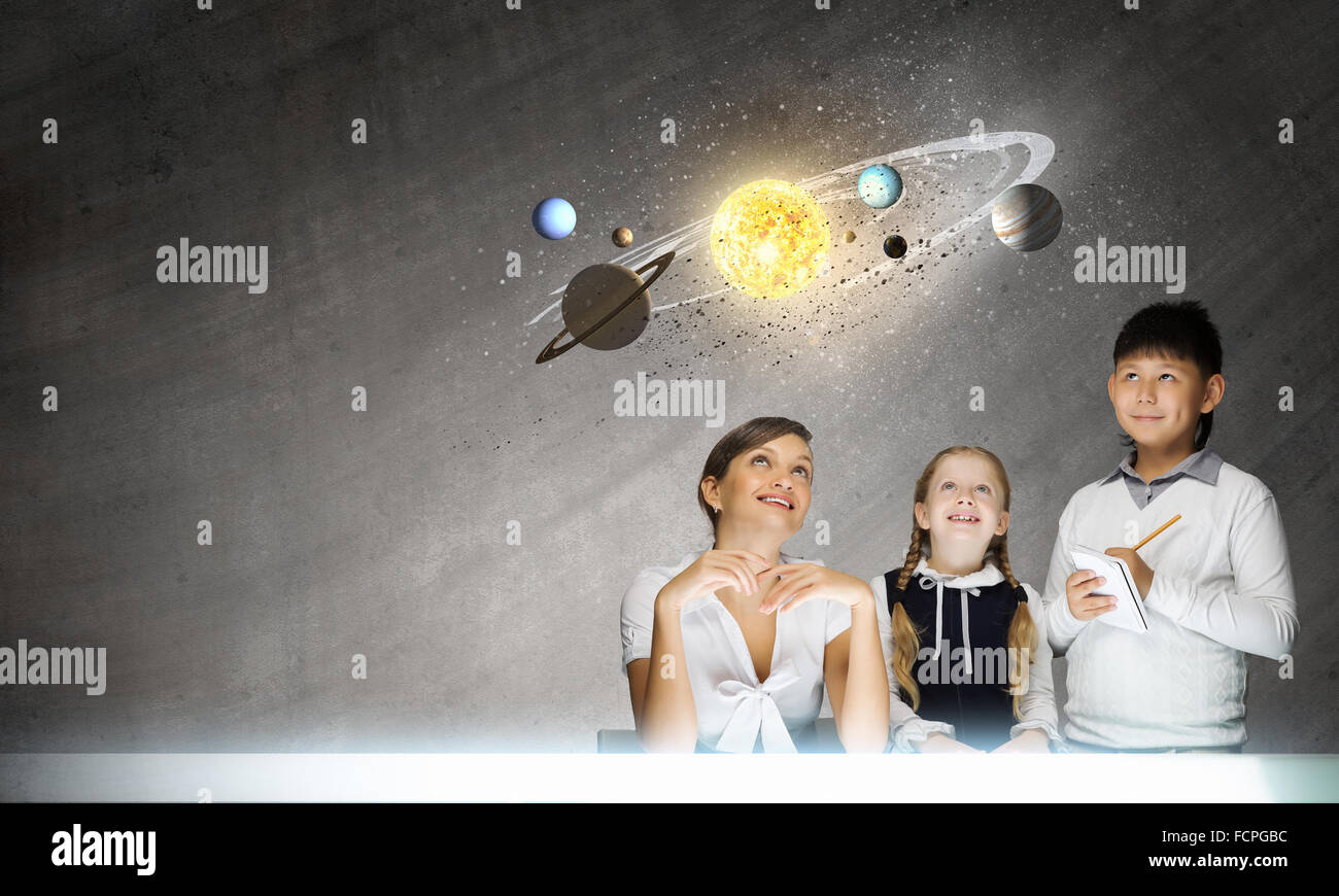 Cute boy of school age and teacher exploring space system Stock Photo ...