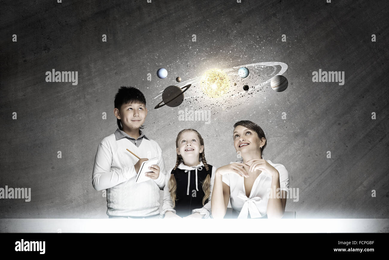 Cute boy of school age and teacher exploring space system Stock Photo ...