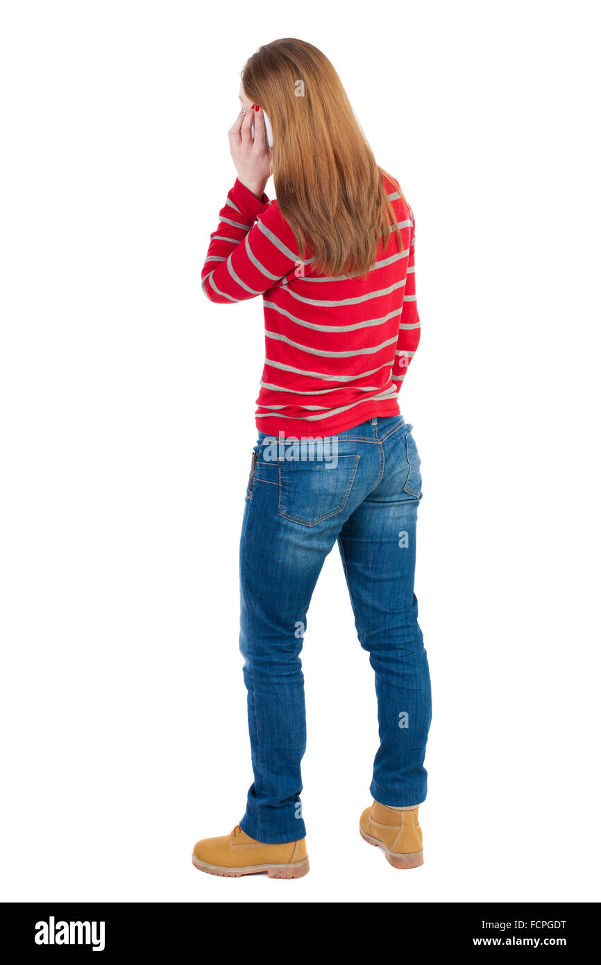 back view of standing young beautiful woman and using a mobile phone ...