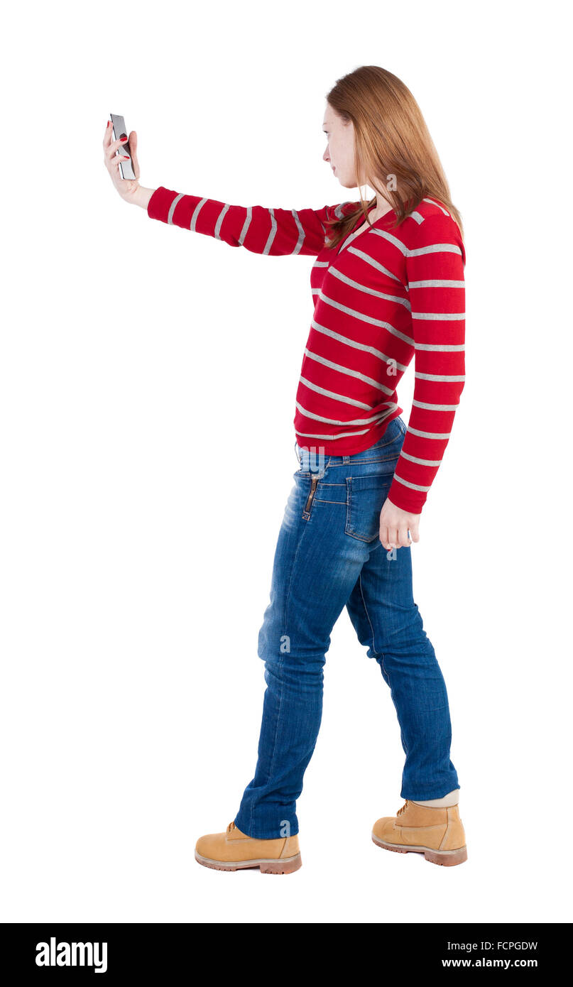 back view of standing young beautiful woman and using a mobile phone ...