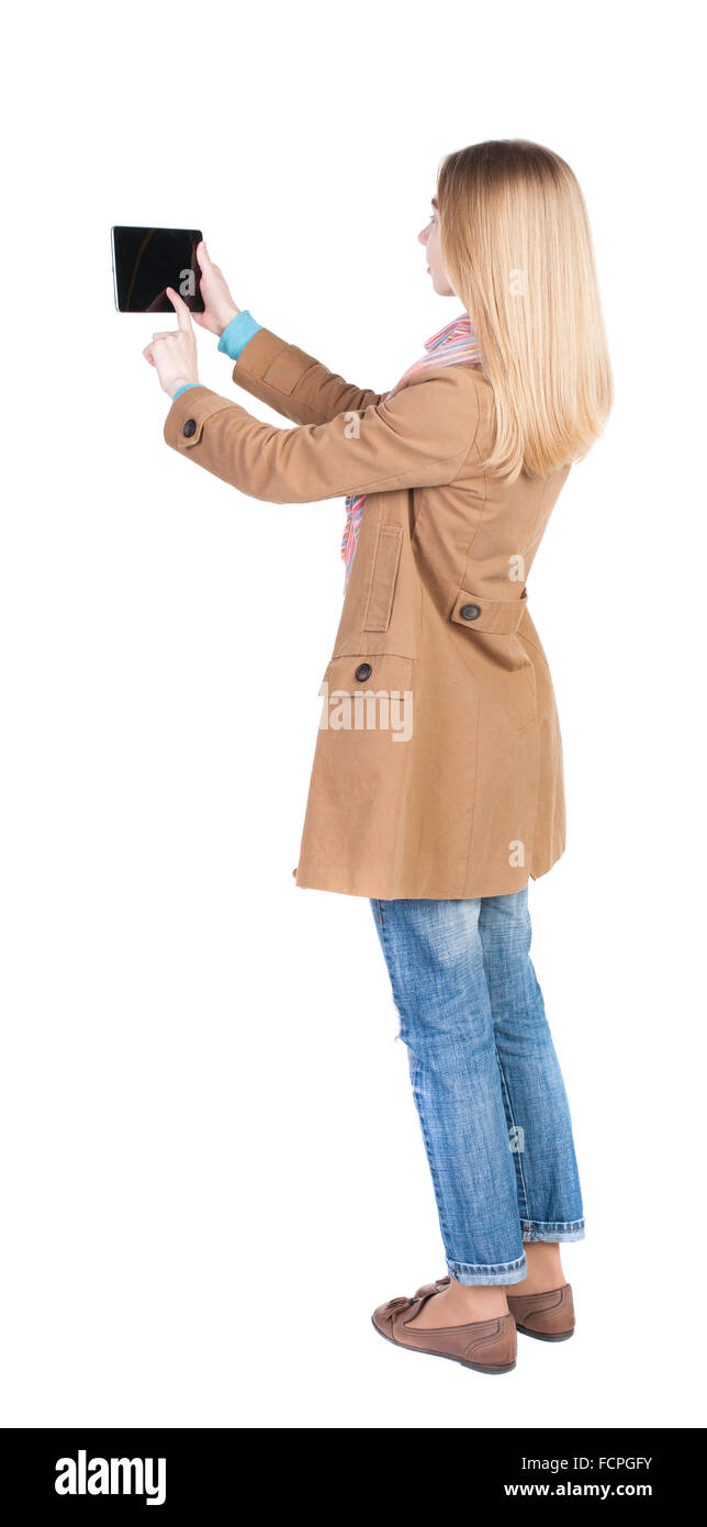 back view of standing young beautiful girl with tablet computer in the ...