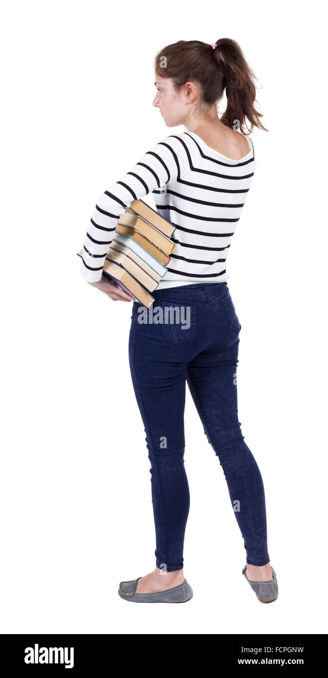 A girl carries a heavy pile of books. back view. Rear view people ...