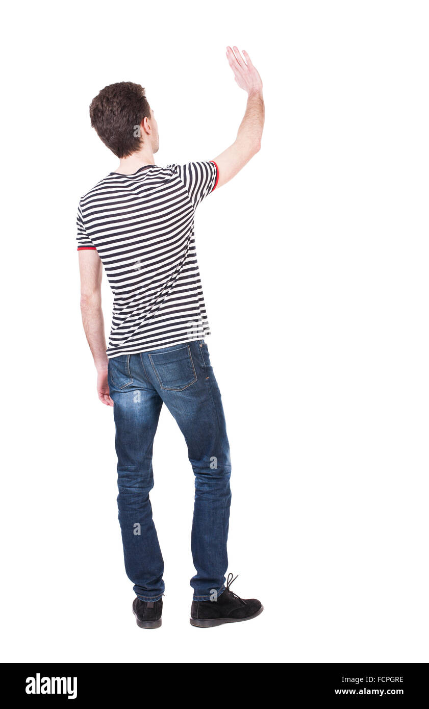 Back view of handsome man greeting waving from his hands. Standing ...