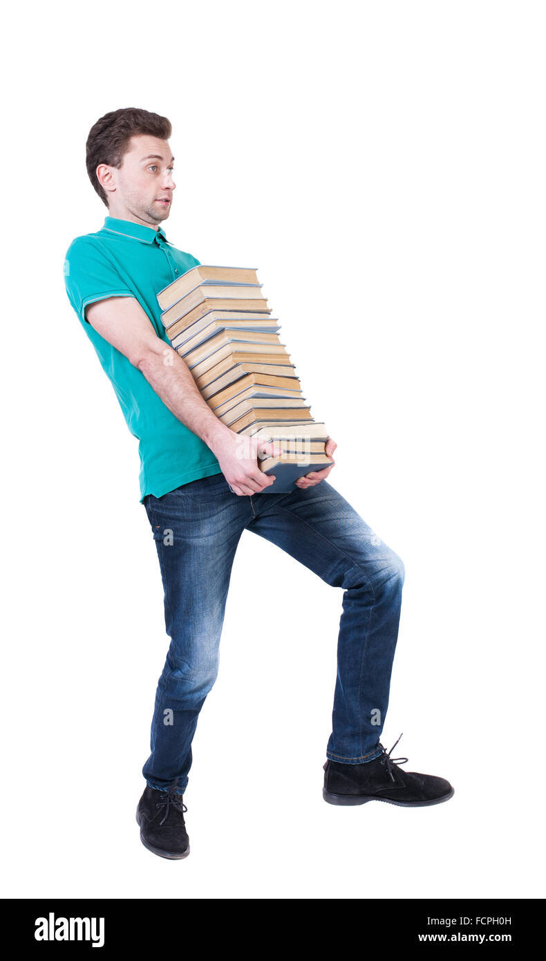 Back view of going handsome man carries a stack of books. walking young ...