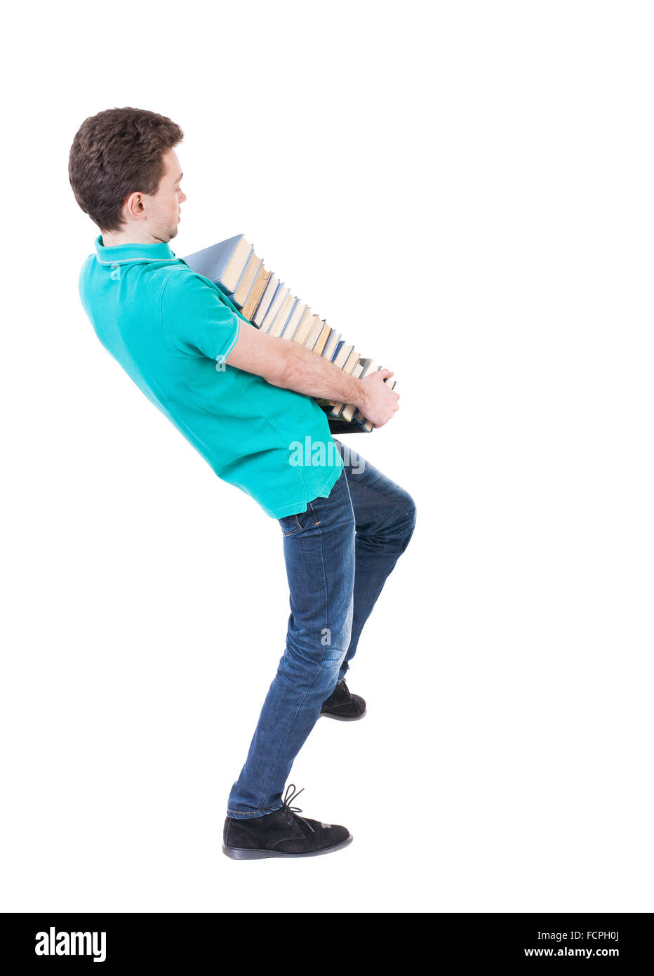 Back view of going handsome man carries a stack of books. walking young ...