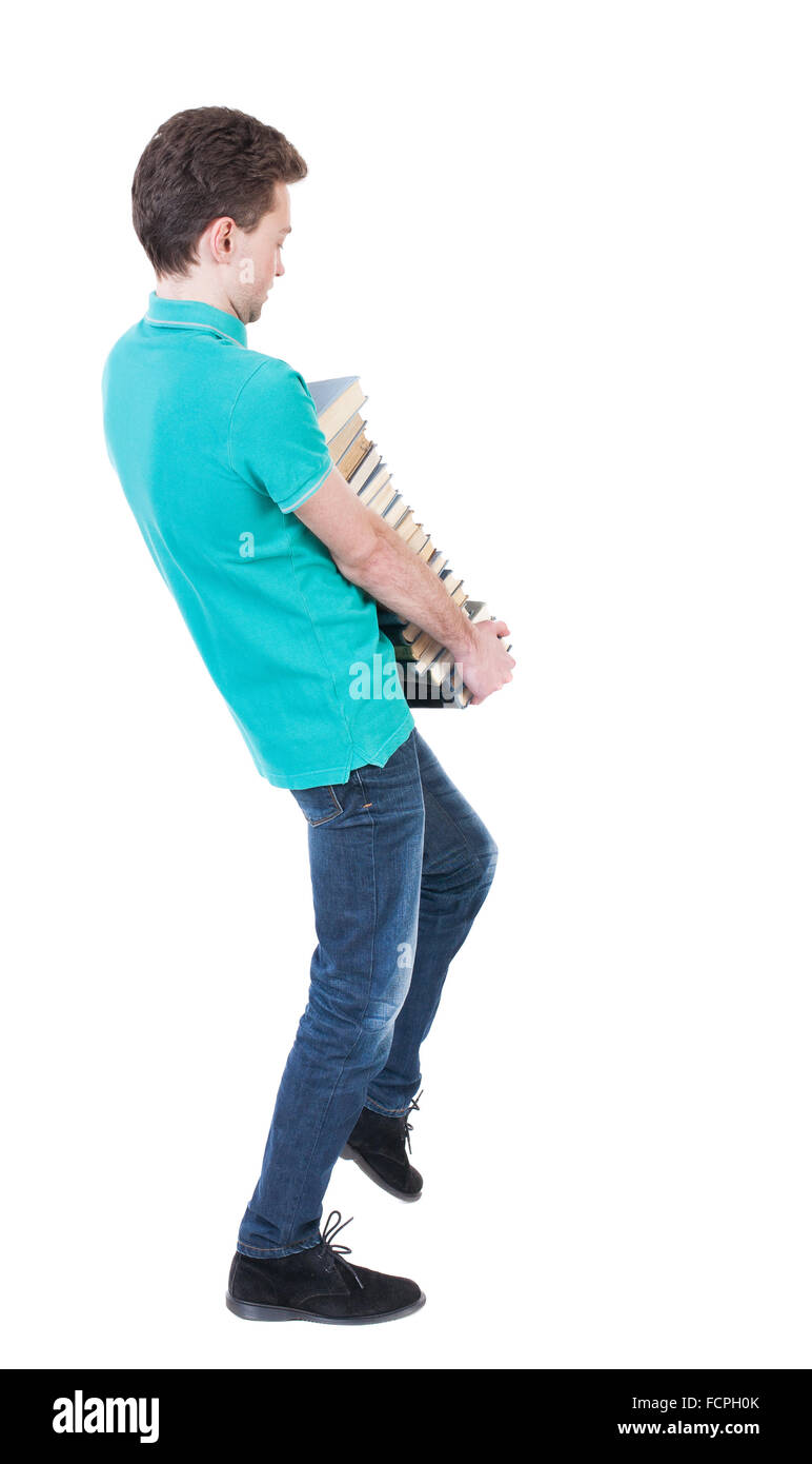 Back view of going handsome man carries a stack of books. walking young ...