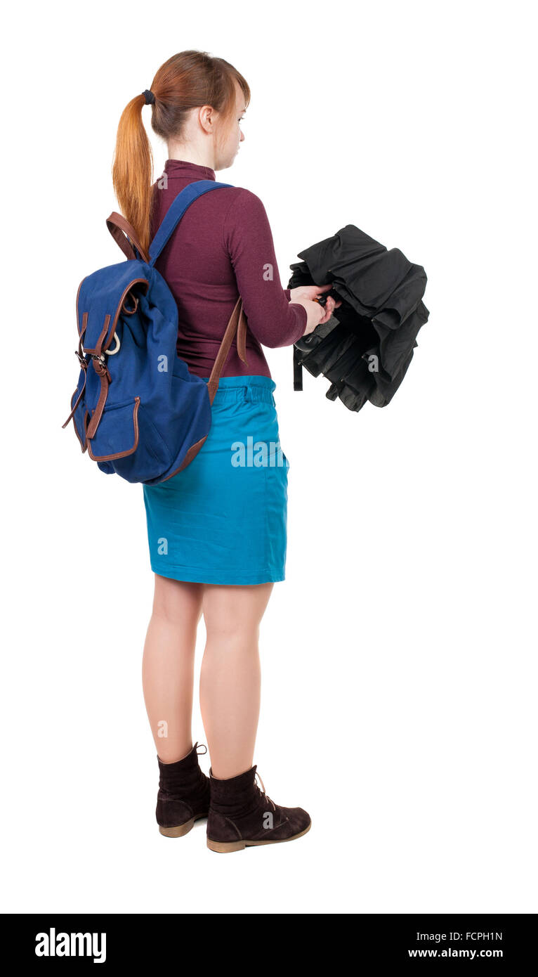 young woman with a backpack under an umbrella. Rear view people ...