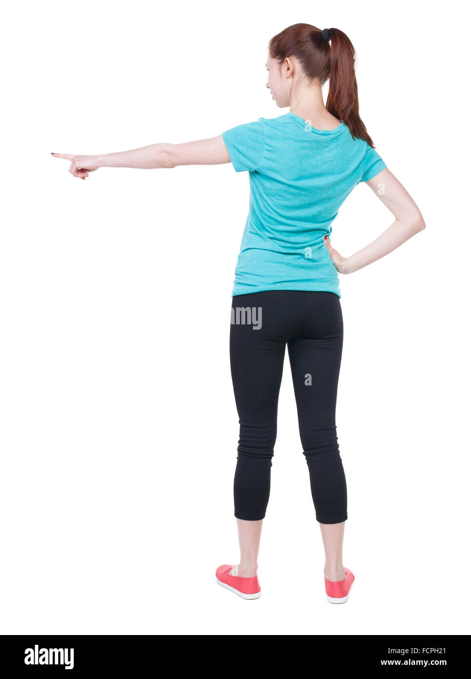 Back view of pointing woman in sportswear. beautiful girl. Rear view ...