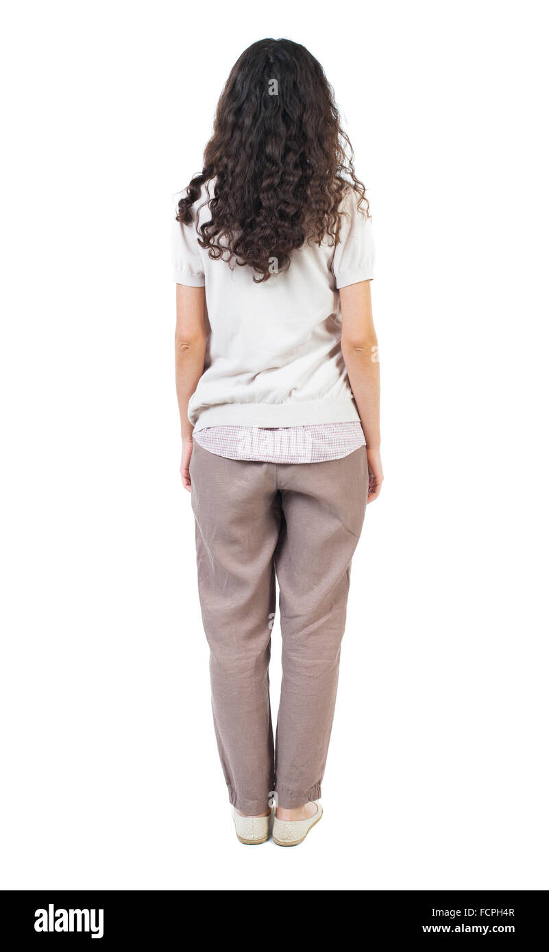 back view of standing young beautiful woman. girl watching. Rear view ...